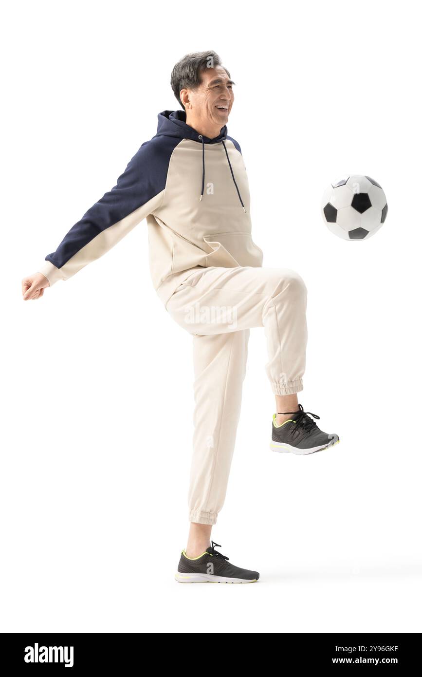 Happy senior man playing football Stock Photo - Alamy