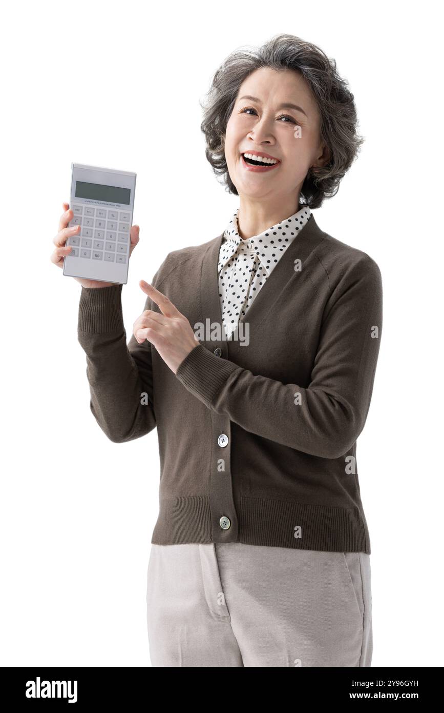 Happy senior woman presenting calculator Stock Photo - Alamy