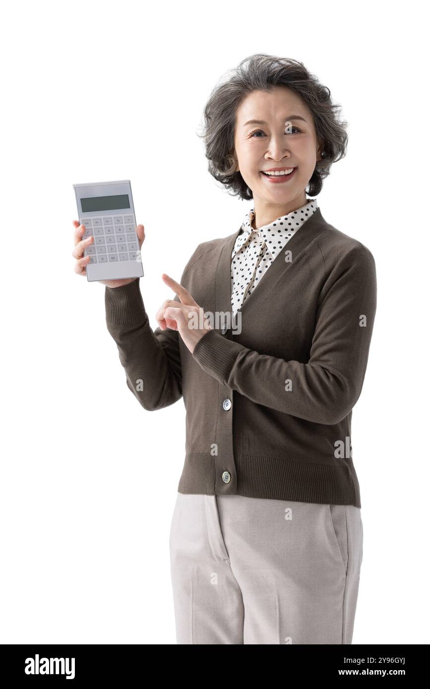 Happy senior woman presenting calculator Stock Photo - Alamy