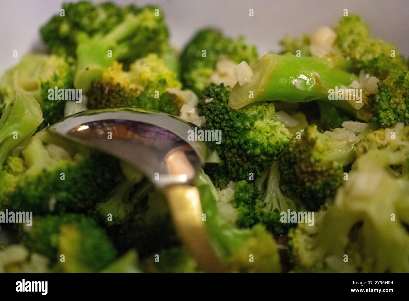 Steamed Garlic Broccoli with serving spoon Stock Photo - Alamy