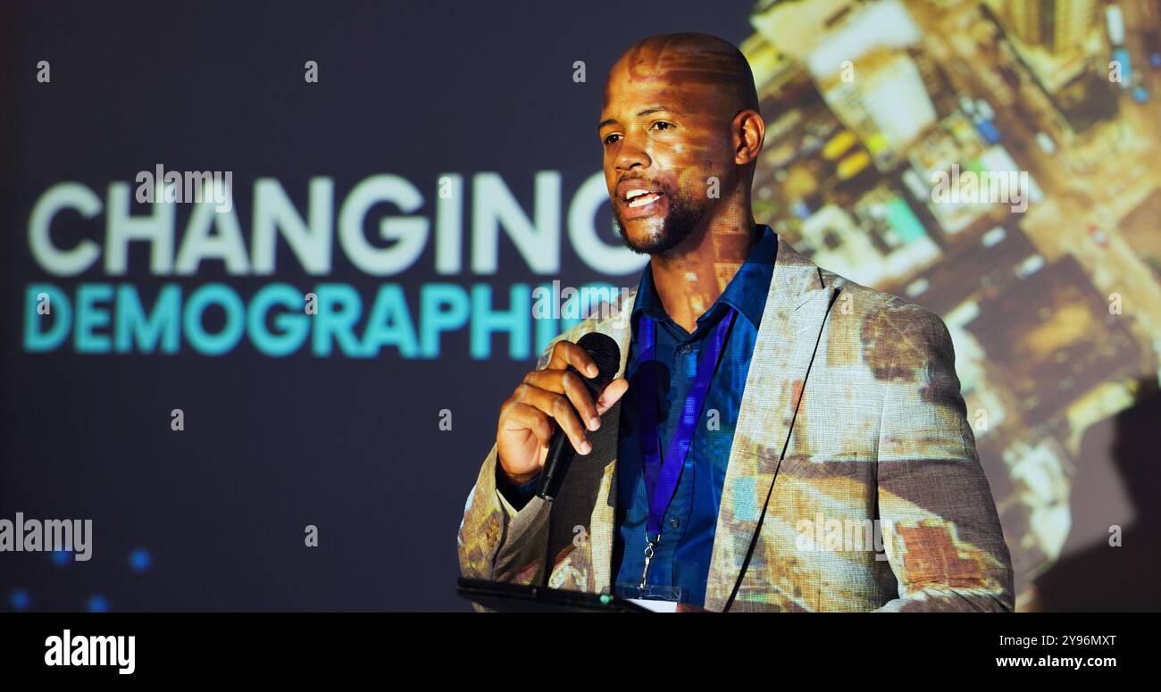 Presenter, conference and black man on a stage with demographics for ...
