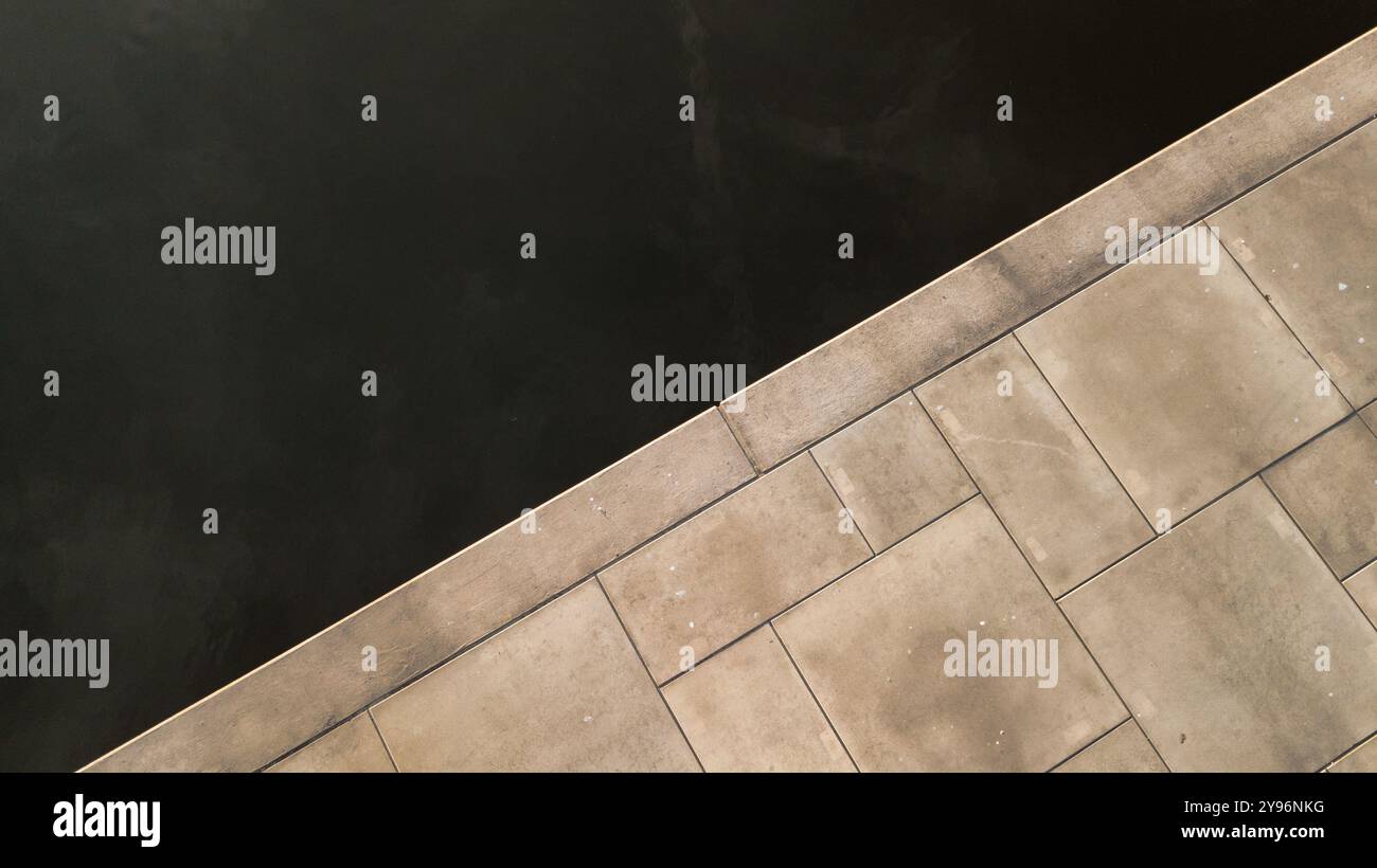 Granite stone pavement and water background, aerial top drone view of ...