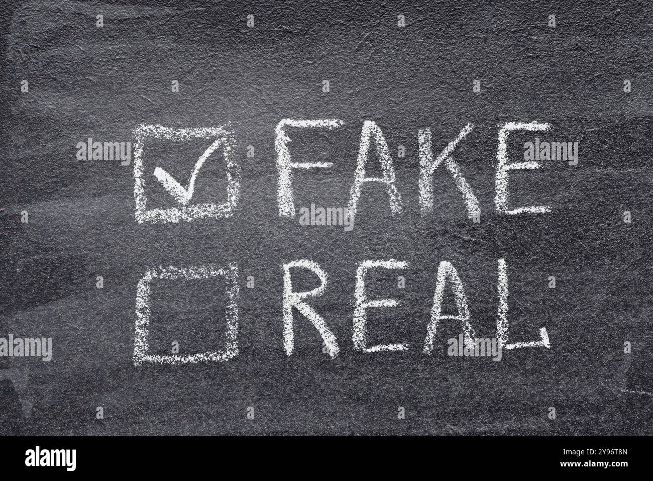 fake or real checkboxes written on chalkboard, word fake is marked ...