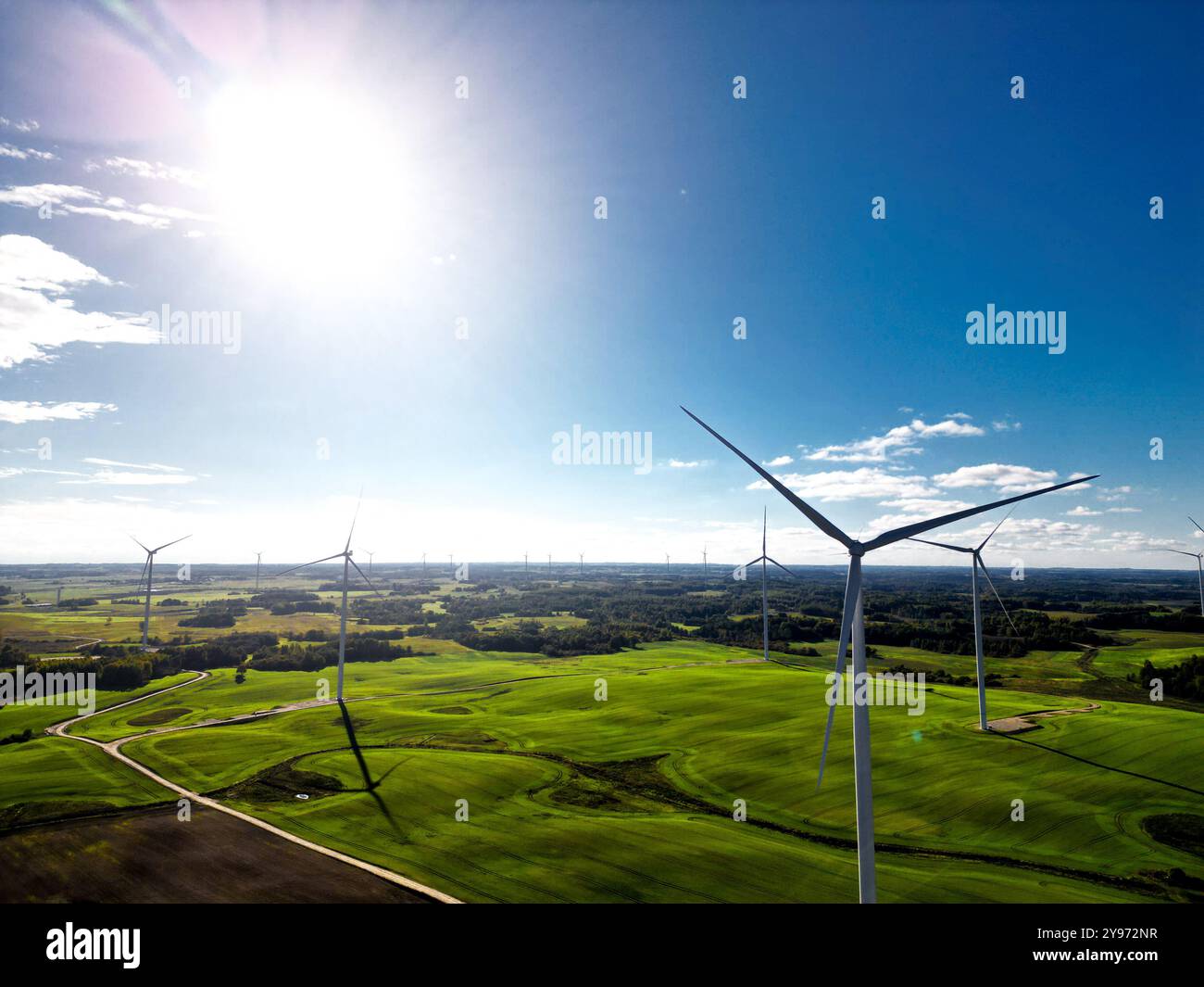 Wind power plants in the large field Stock Photo - Alamy