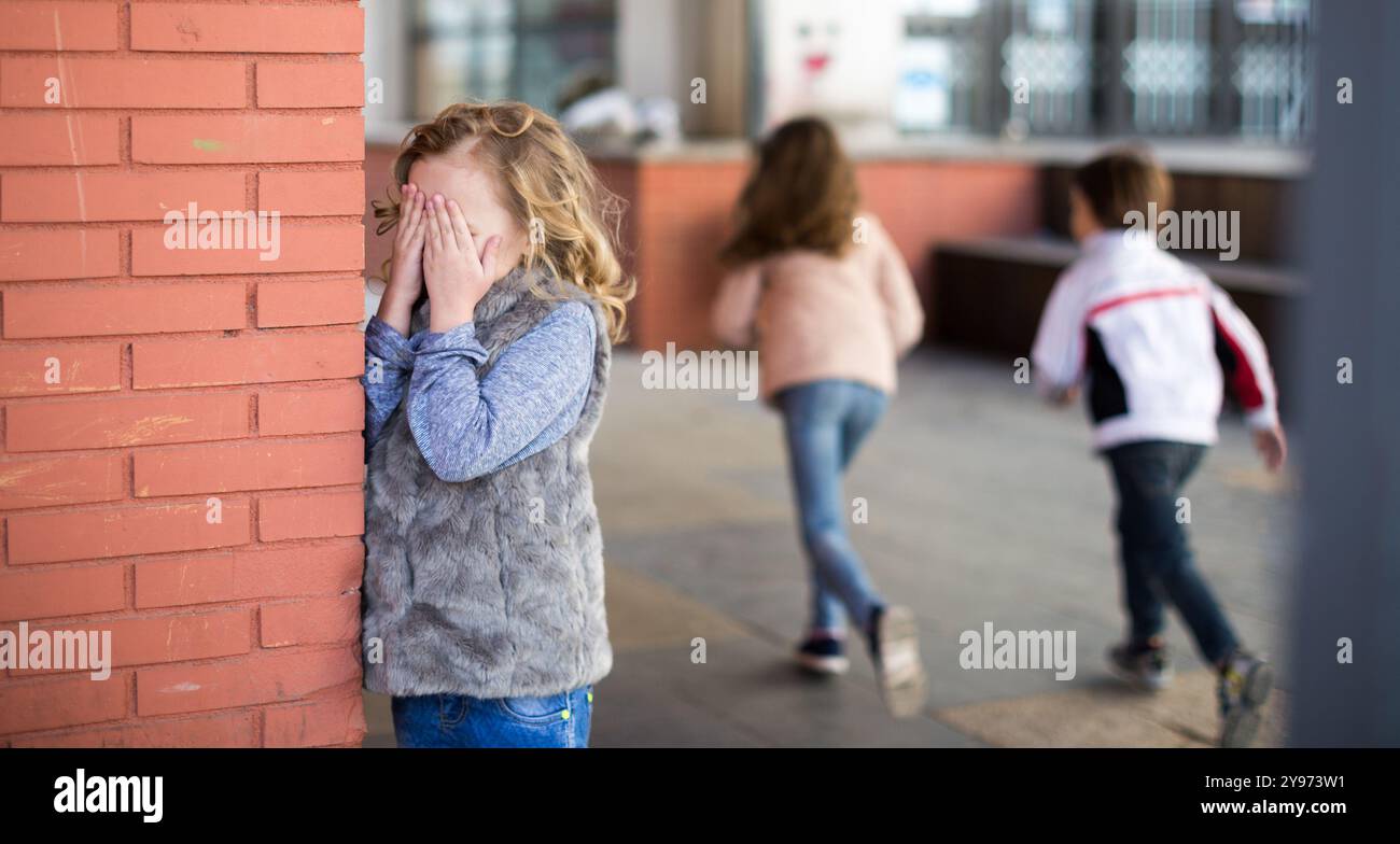 Children playing hide and seek in the schoolyard Stock Photo - Alamy