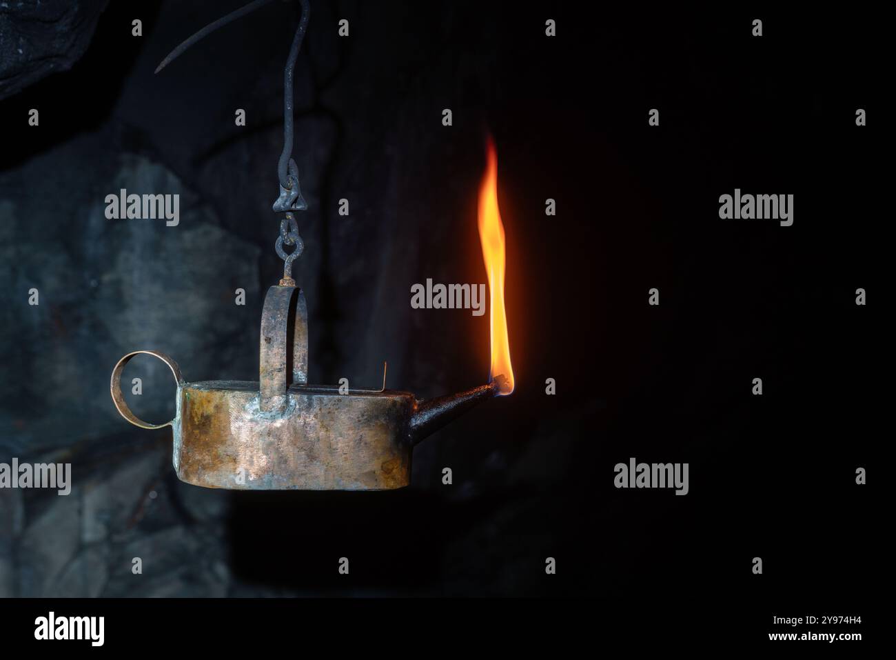 Lit historic mining oil lamp hanging in Flaschar's mine (Flascharův důl ...