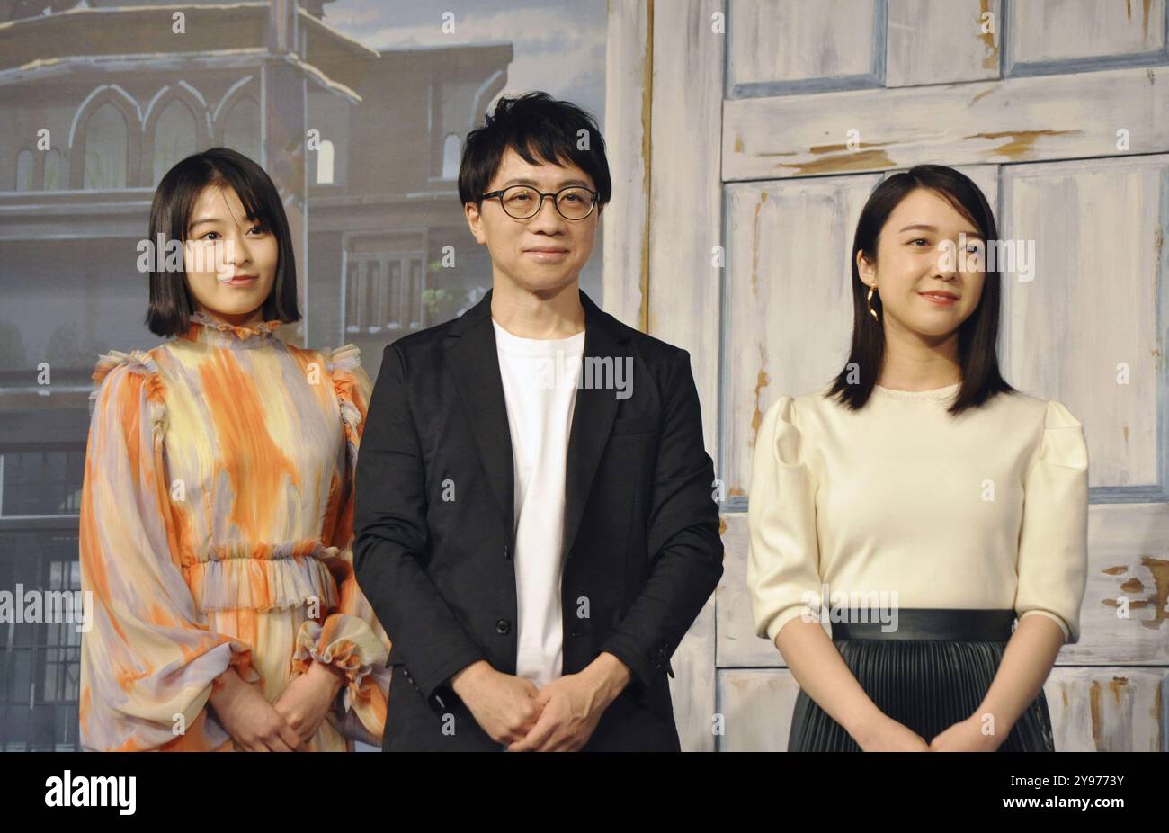 Japanese film director Makoto Shinkai (C) poses for photos during a press conference announcing ...