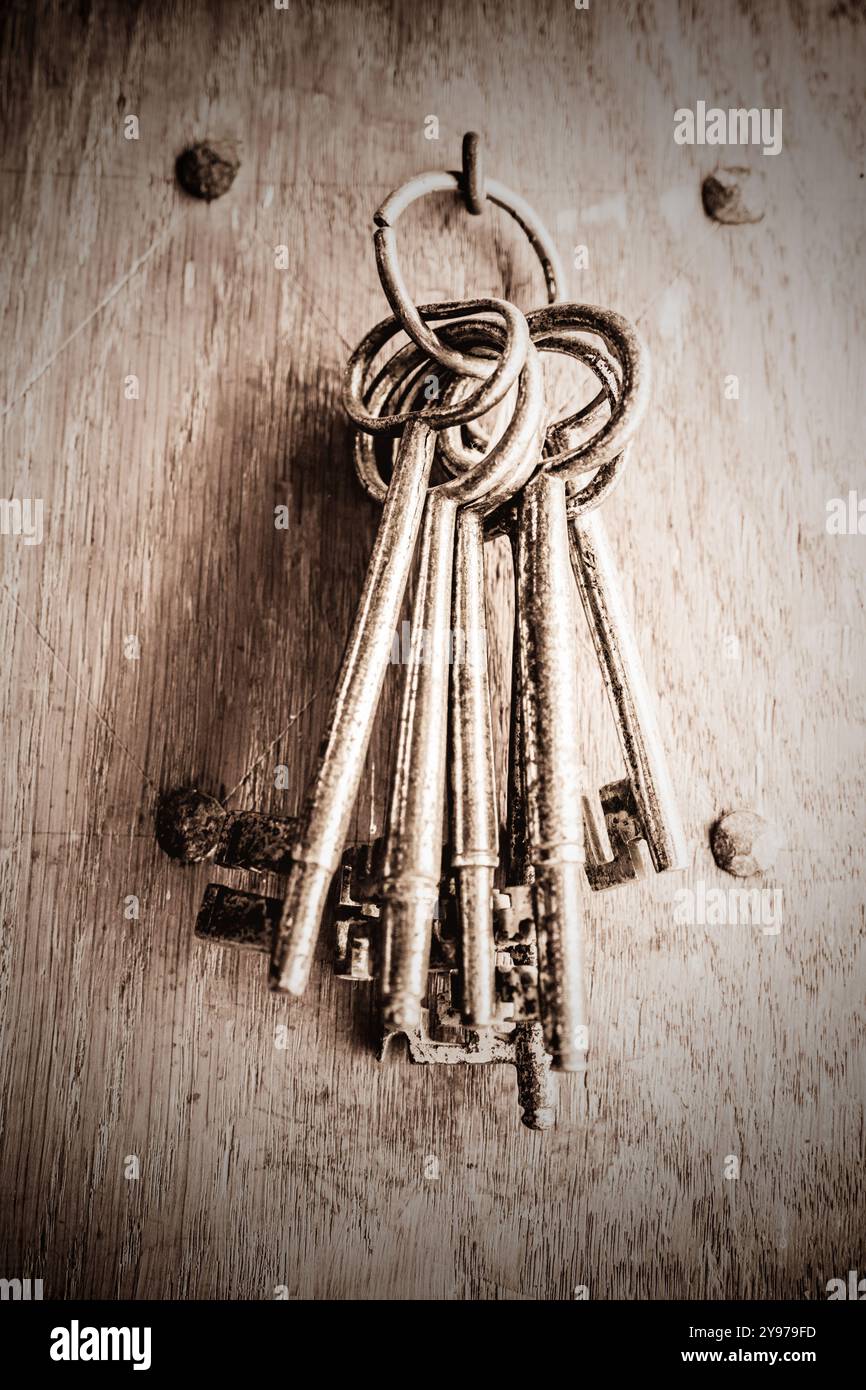 Bunch of old fashioned keys hanging up from a hook Stock Photo - Alamy