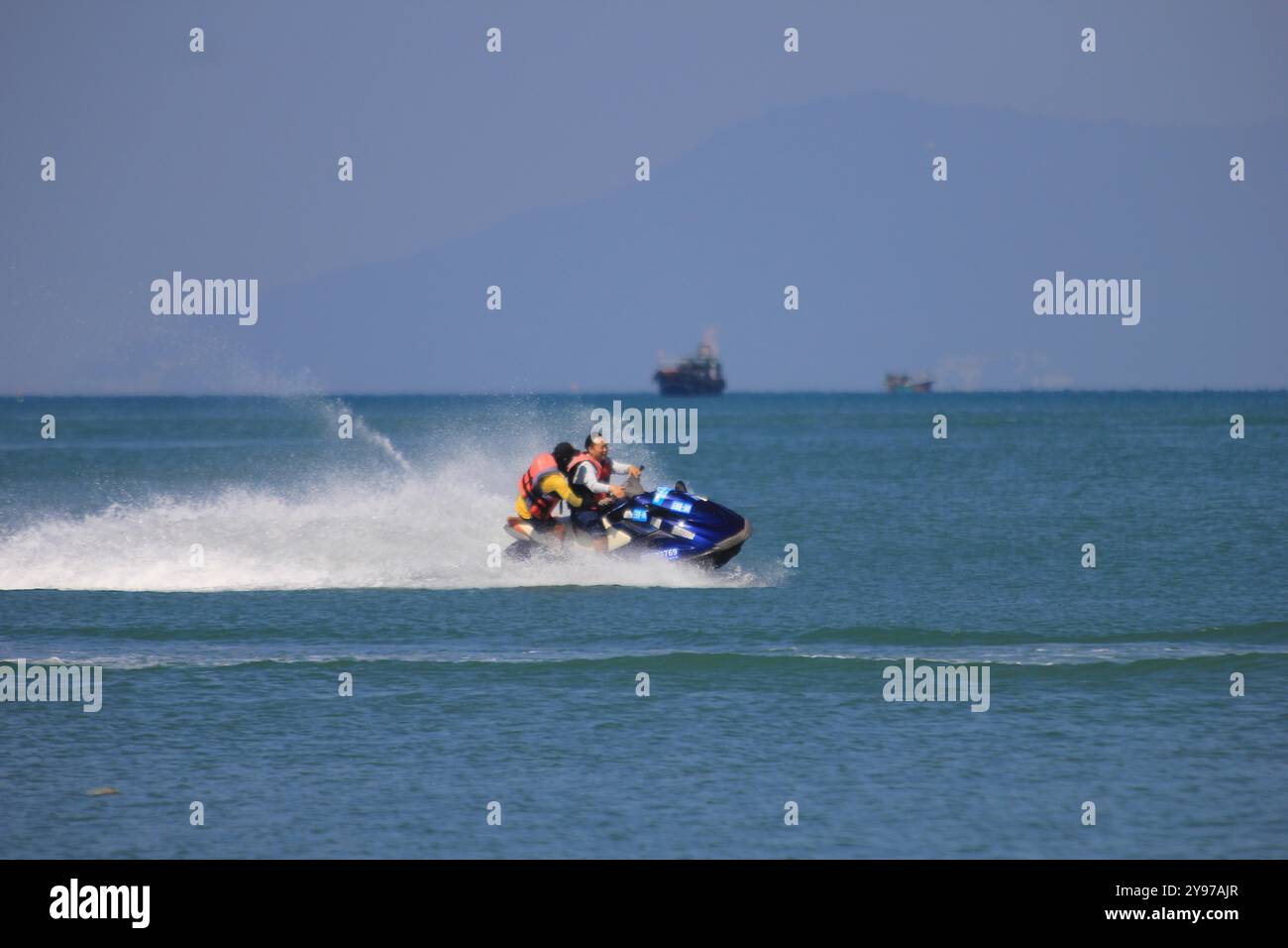 Tourists play at the seaside in Sanya City, southernmost China's Hainan ...
