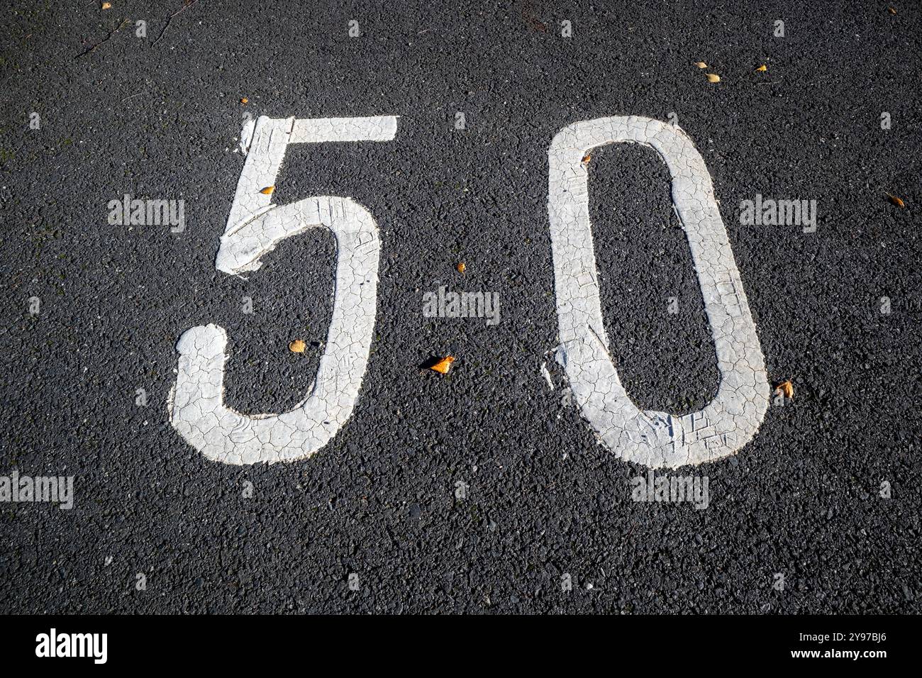 Number fifty 50 painted in white on tarmac Stock Photo - Alamy