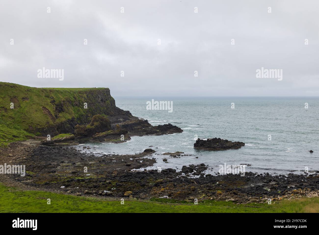 Bay of the Cow near Giant Causeway features rugged cliffs and rocky ...
