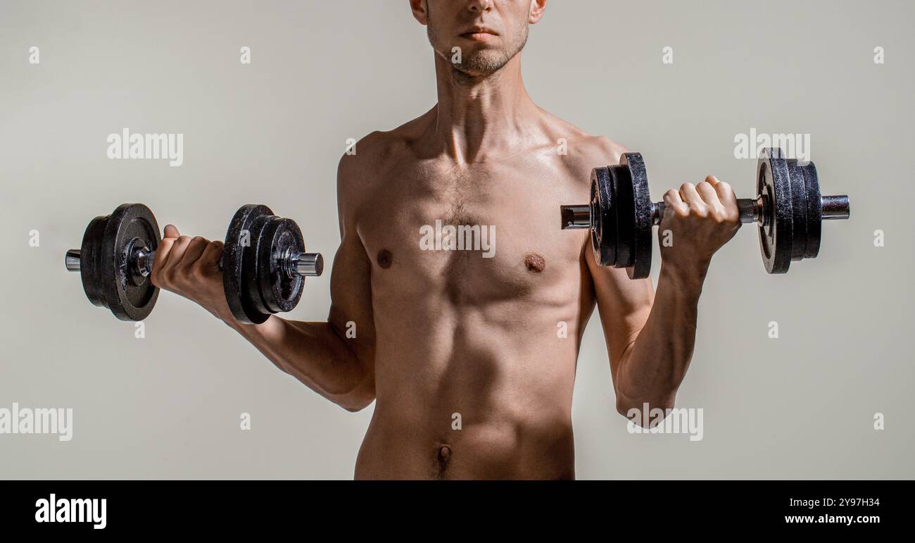 Skinny man, dumbbells. Skinny man goes in for sports, builds muscles ...