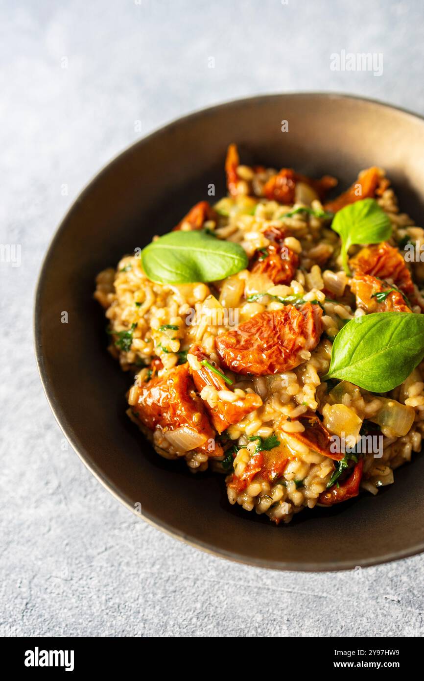Sun-dried tomato risotto with basil Stock Photo - Alamy