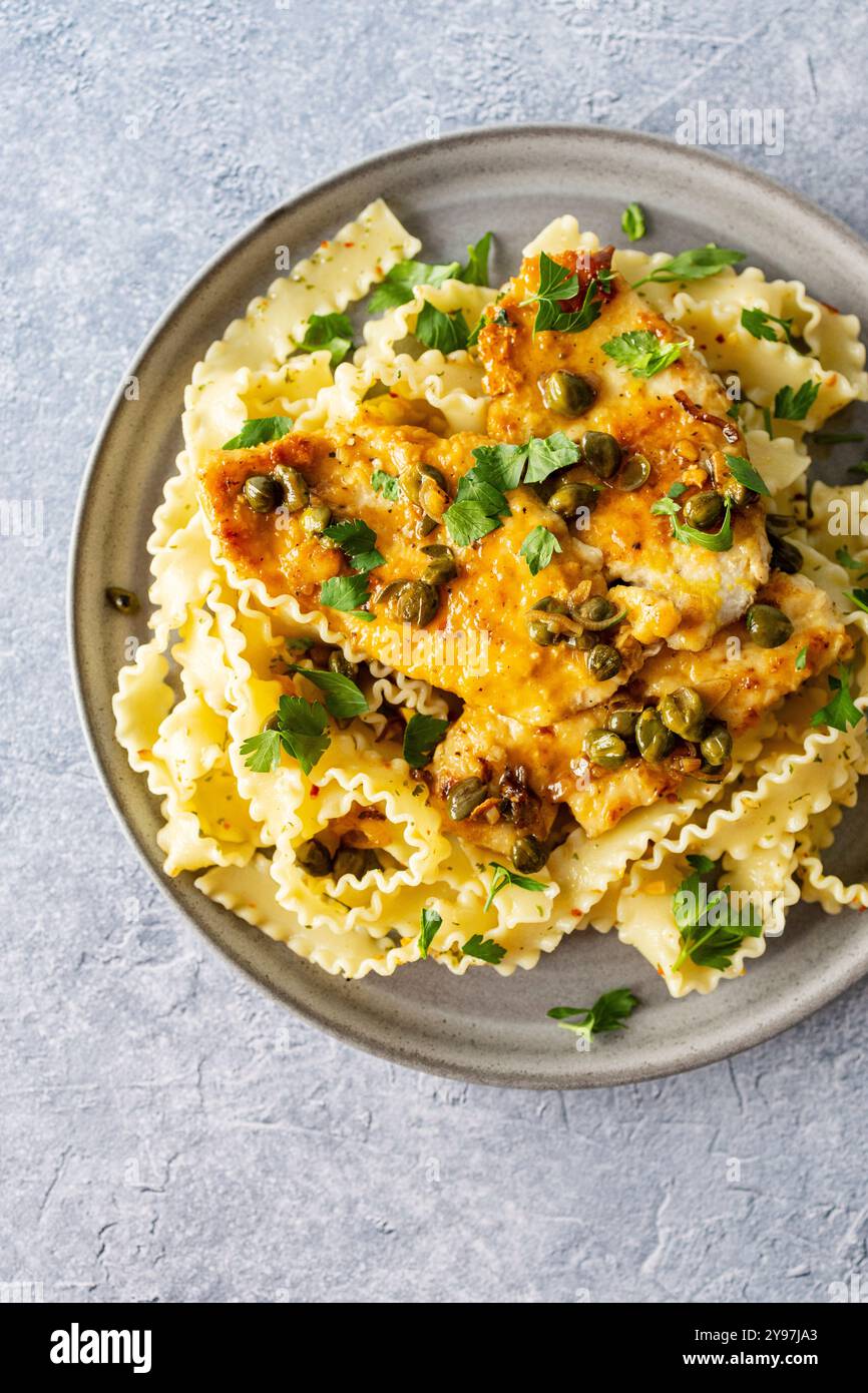 Chicken picatta with capers and pasta Stock Photo - Alamy