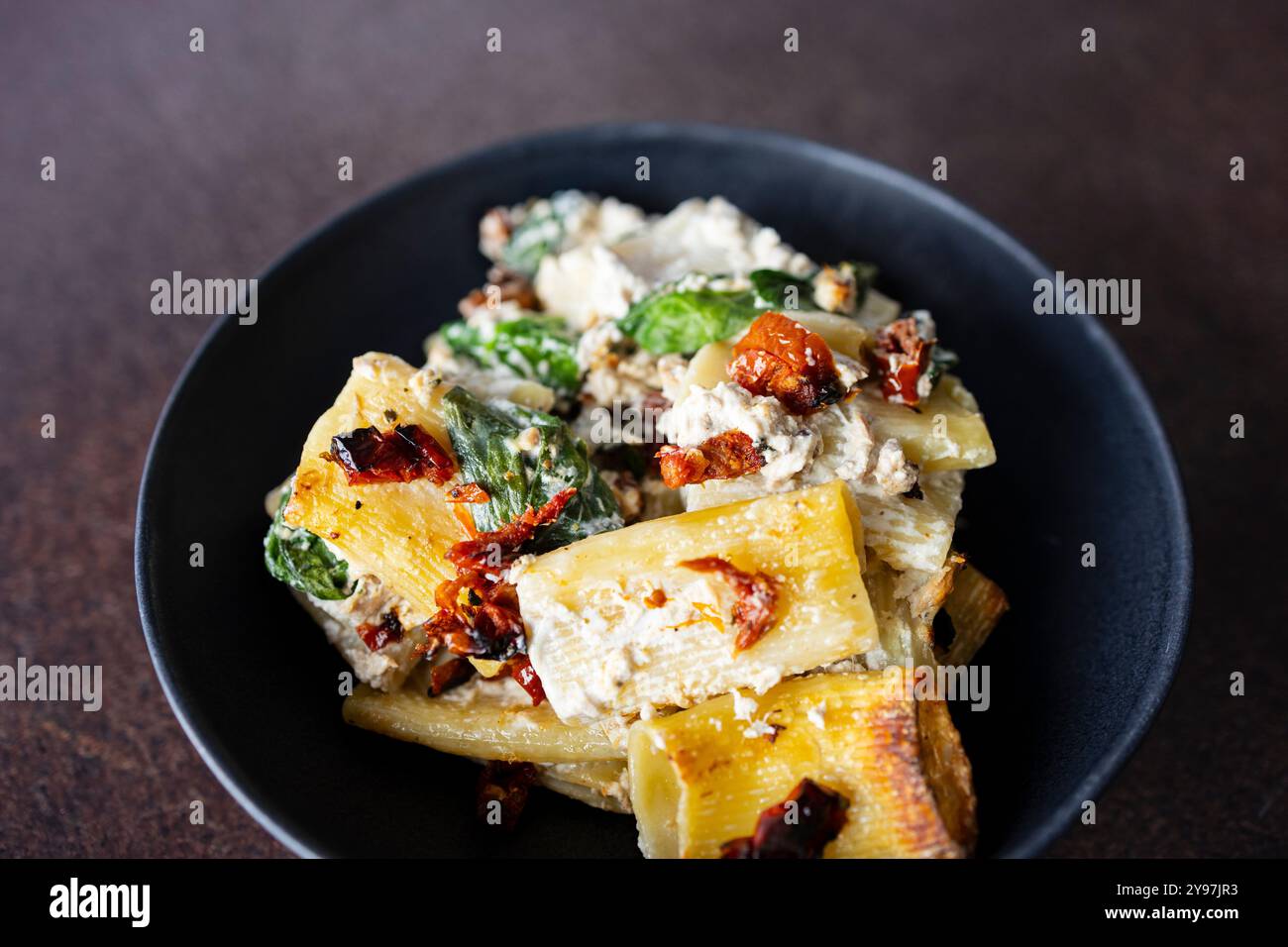 Rigatti, tuna, ricotta, spinach, dried tomato Stock Photo - Alamy
