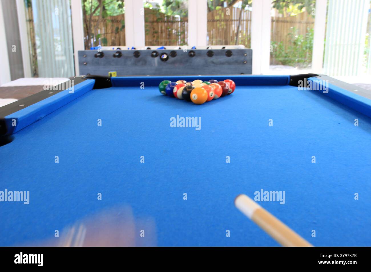 Billiard balls with numbers on them on a blue pool table in action of ...