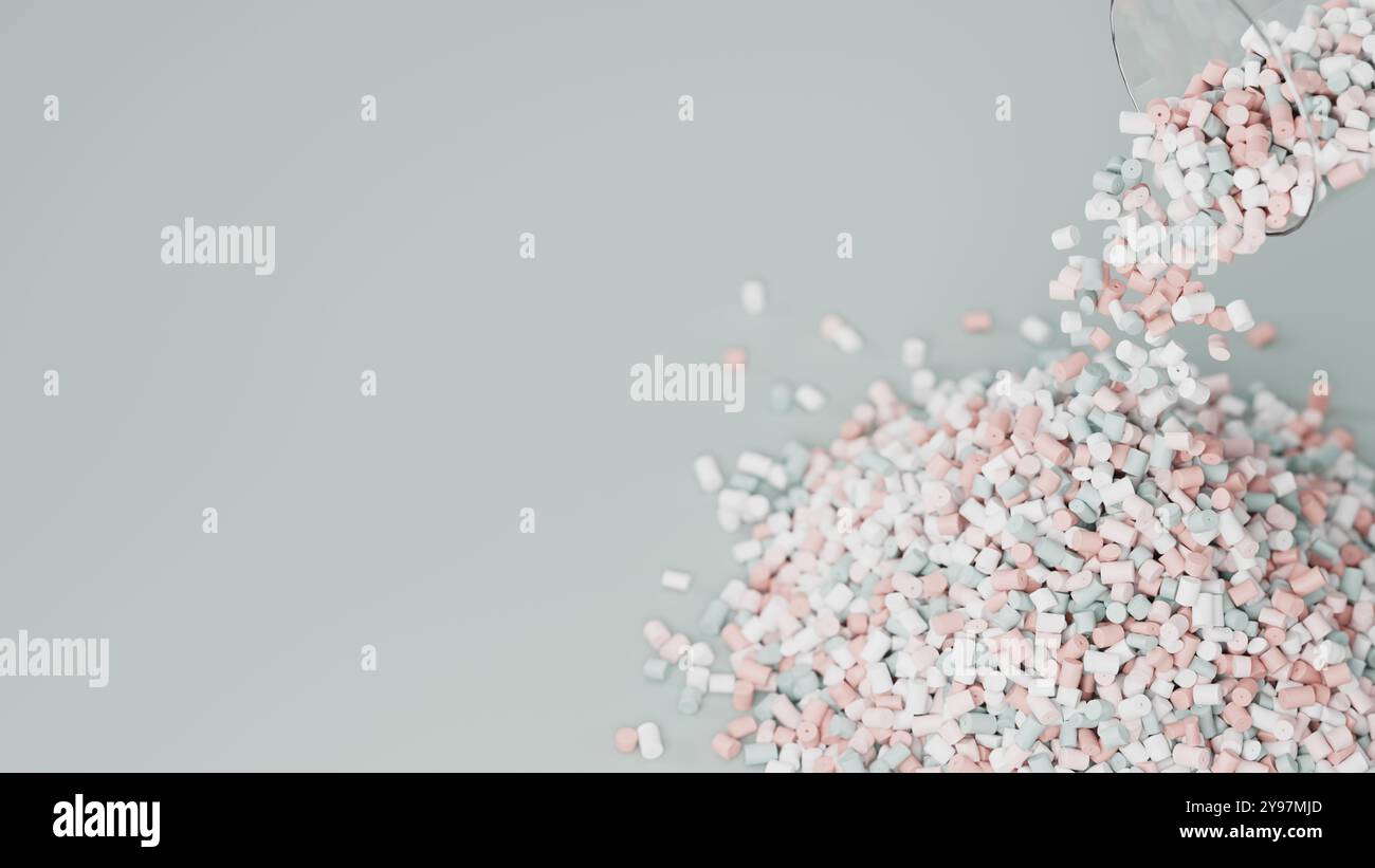 Top view of colorful pastel plastic polypropylene granules pouring from ...