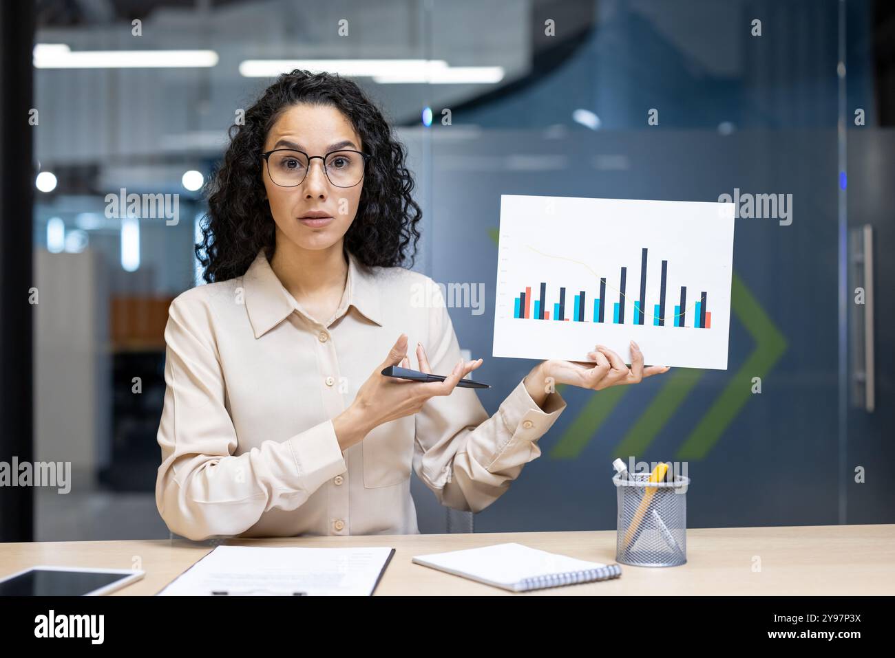 Businesswoman presenting data analysis during video call, holding bar ...