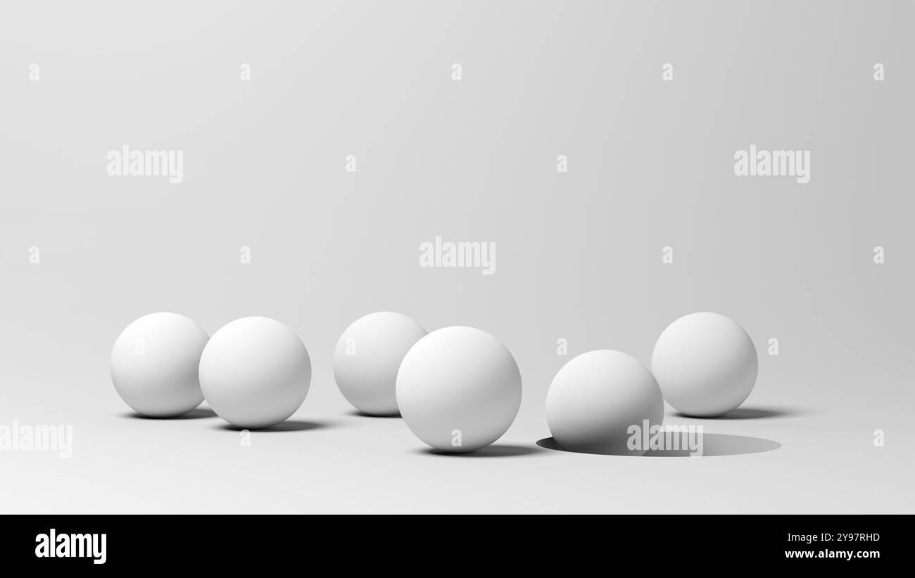 Six white spheres. One sphere falling into the hole. Balls. Isolated ...