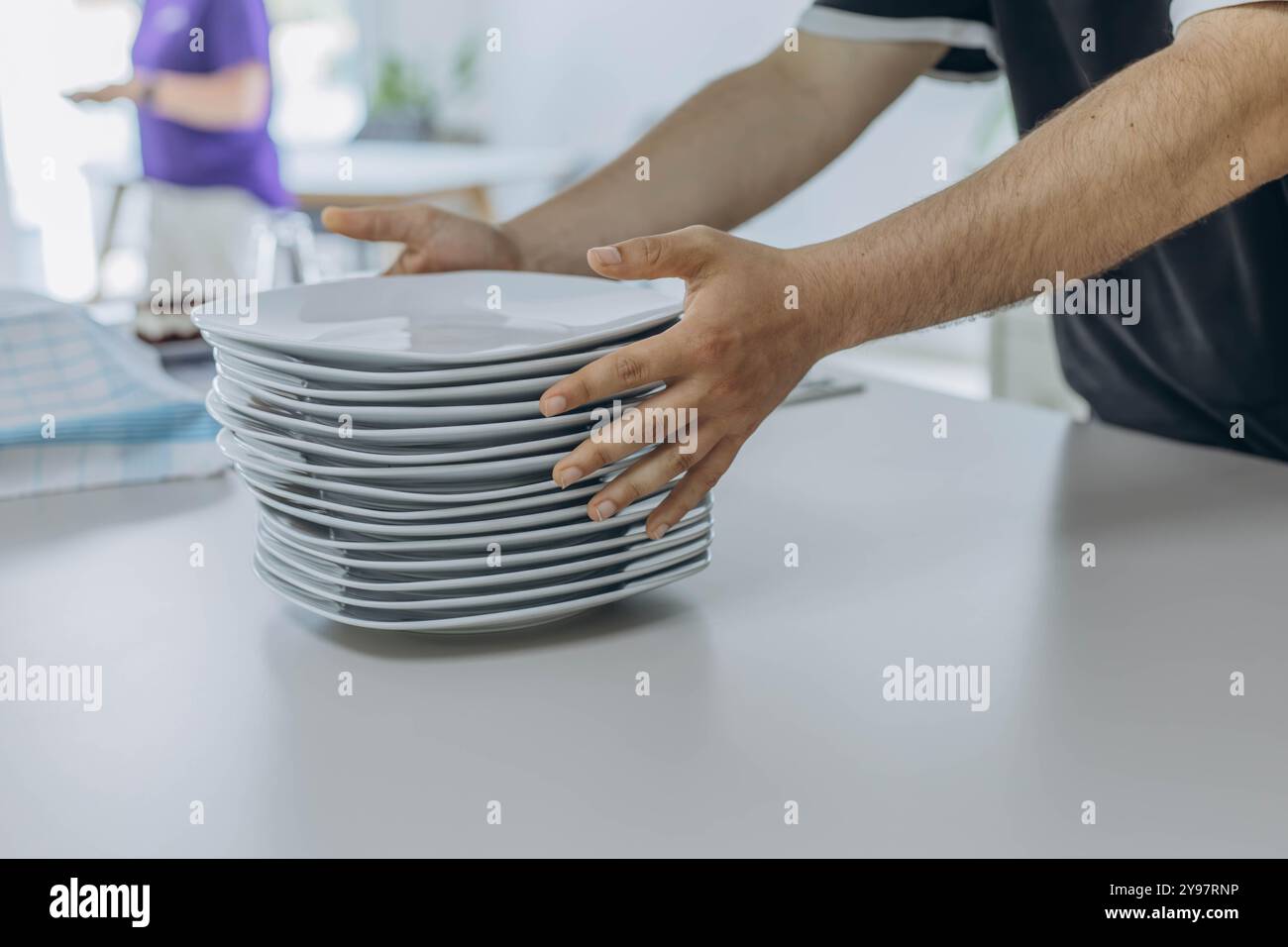 Hands holding stack of plates hi-res stock photography and images - Alamy