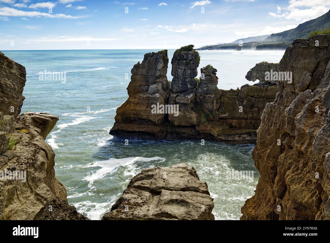 Waves crashing against dramatic limestone cliffs abutting into the ...
