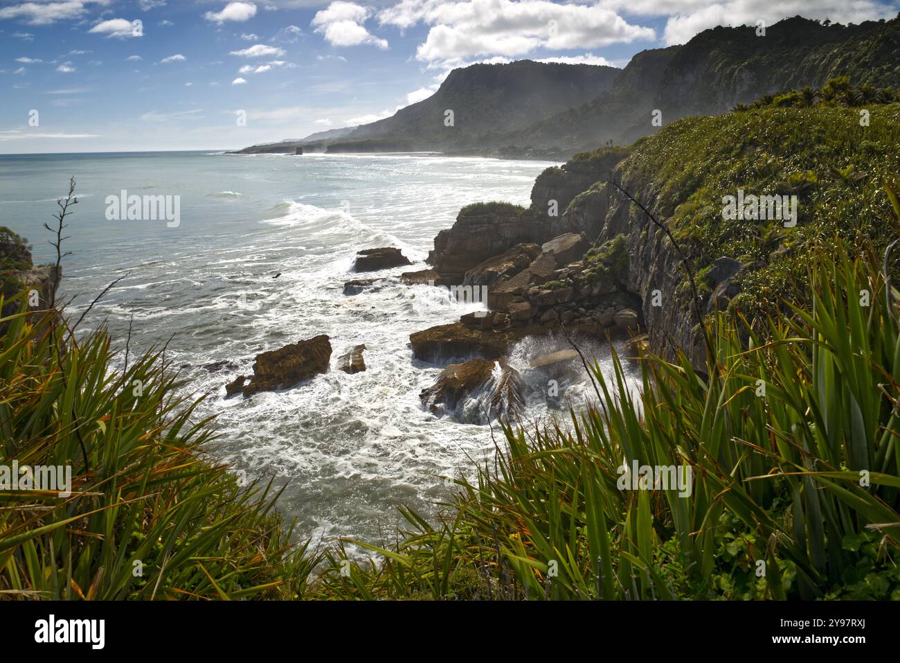 Waves crashing against dramatic limestone cliffs abutting into the ...