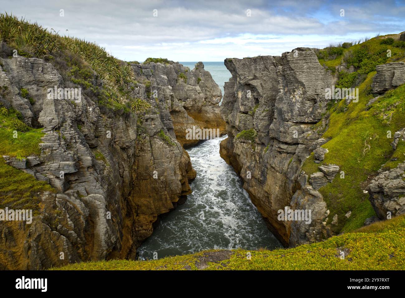 Pancake Rocks, Punakaiki village in South Island, New Zealand - Seawater from surge pool ...