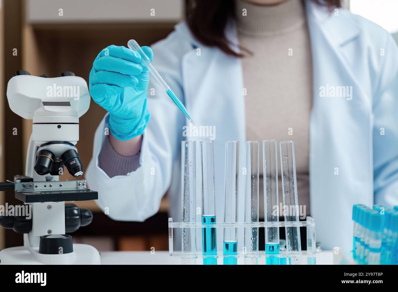 Scientist Conducting Experiment in Modern Laboratory with Test Tubes ...