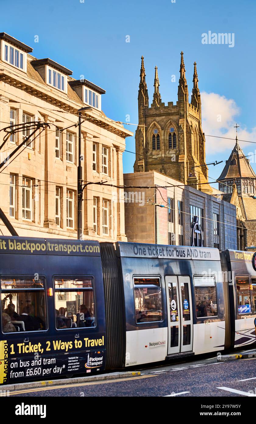 Tram travelling along Talbot Road infront of office block and catholic ...