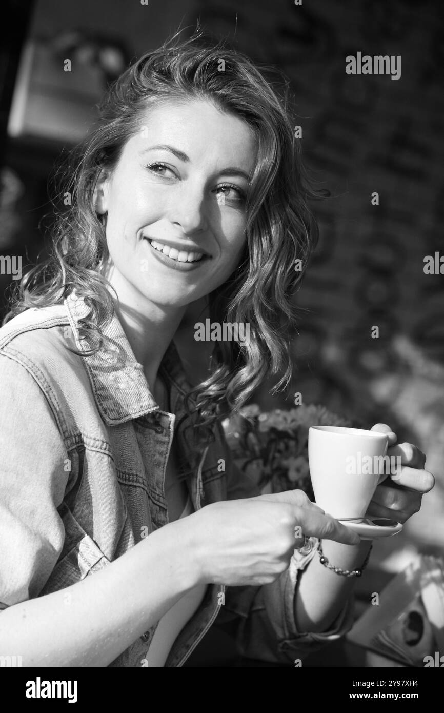 portrait of cheerful pretty mid adult woman with ginger hair sitting at ...