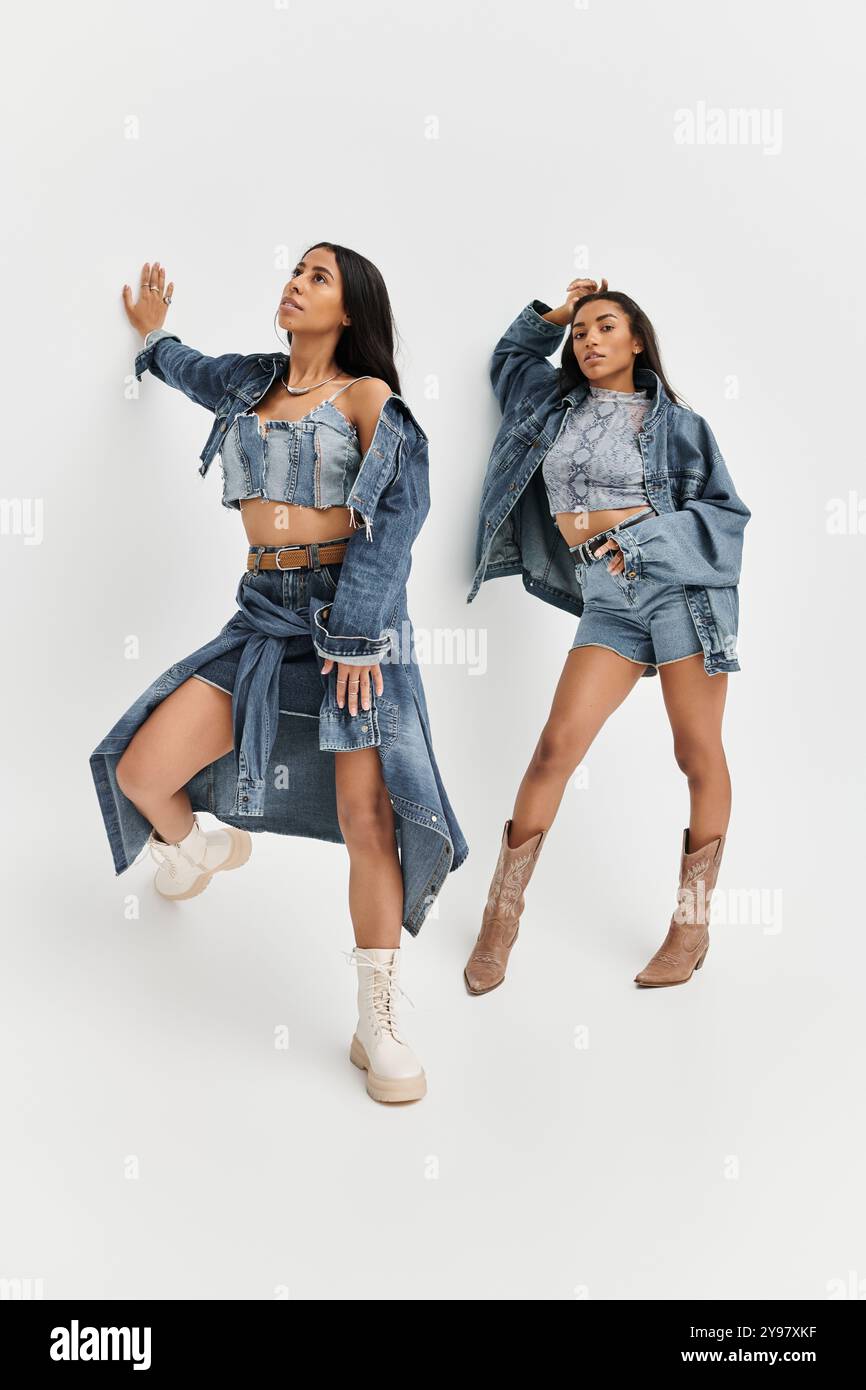 A fashion forward young woman displays her stylish denim ensemble while ...