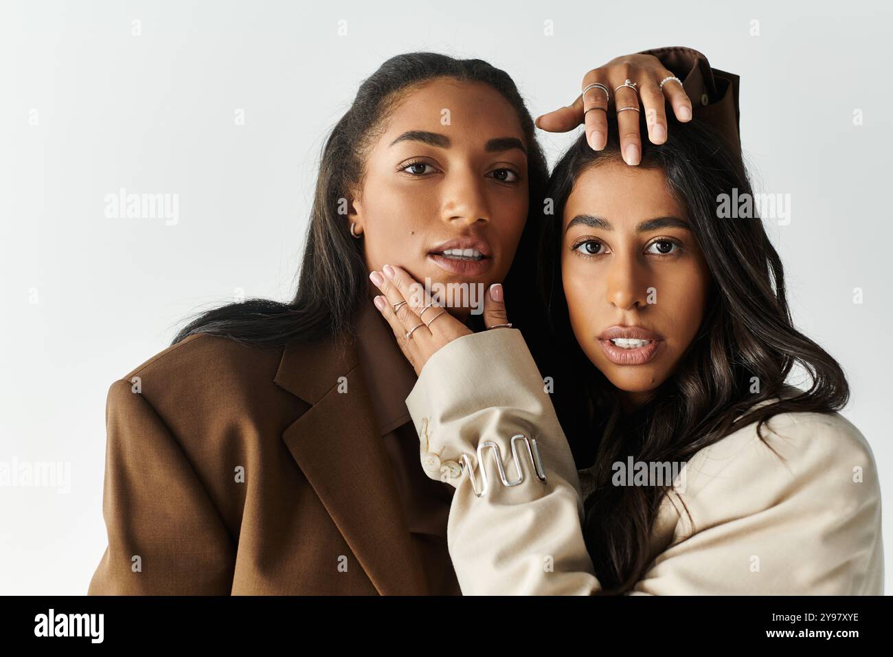 Two fashionable friends express their unique styles while posing ...