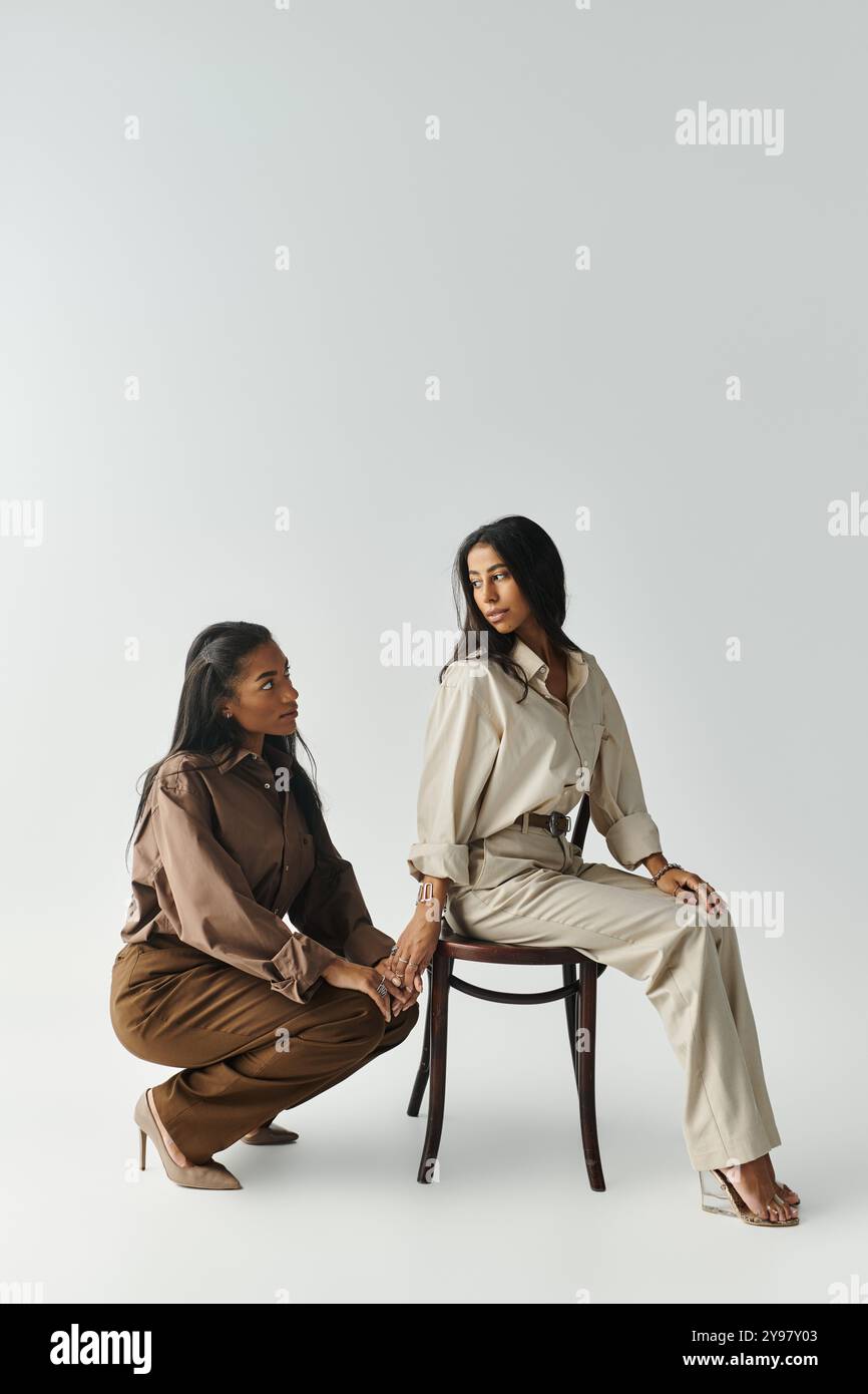 Two fashionable friends laugh and pose playfully in a bright, modern ...