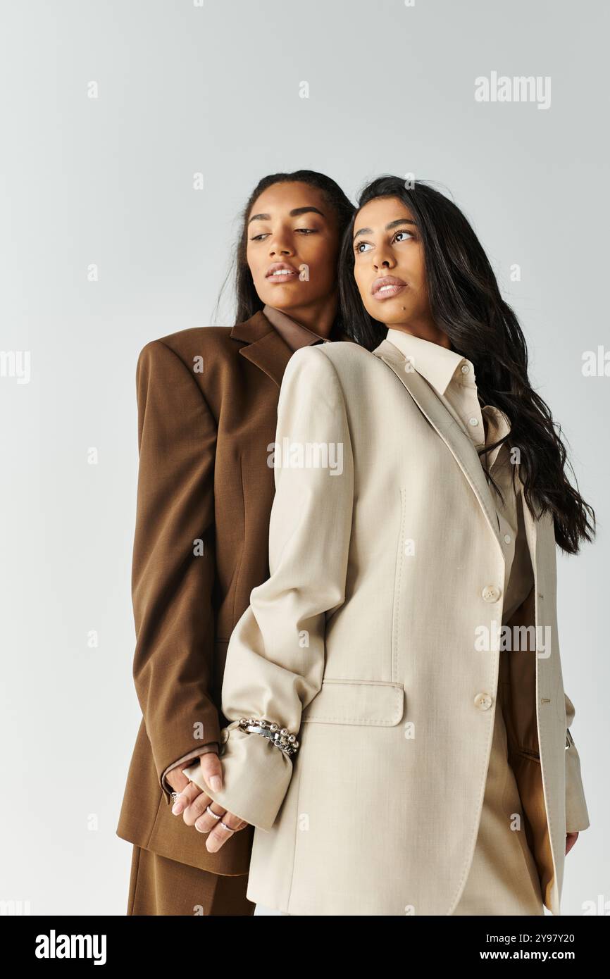 Two fashionable young women pose confidently together, highlighting ...