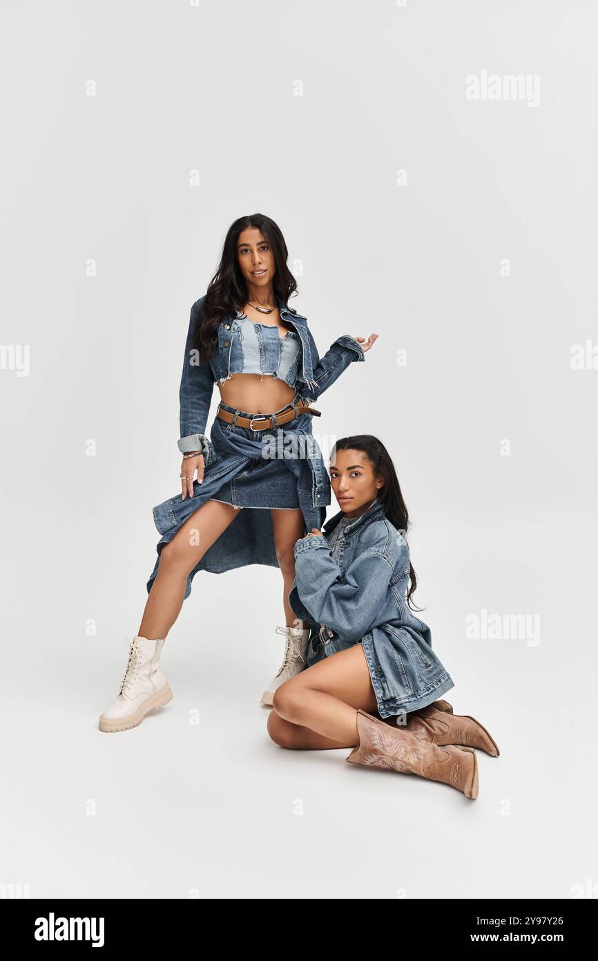 Two fashionable young women showcase their stylish denim outfits while ...