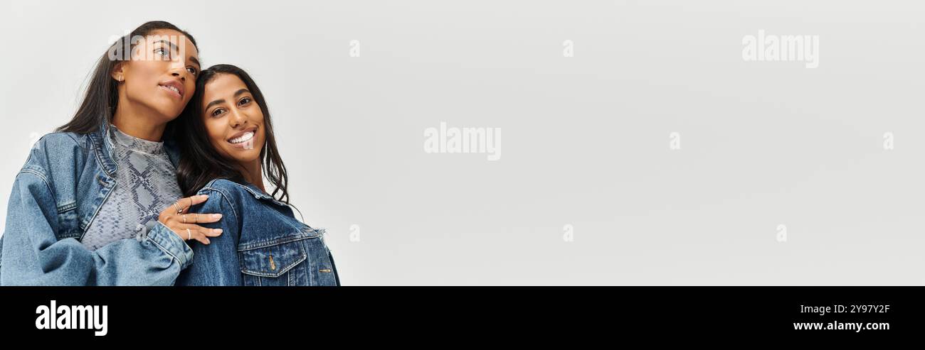 Two friends radiate joy while posing together in trendy denim attire ...