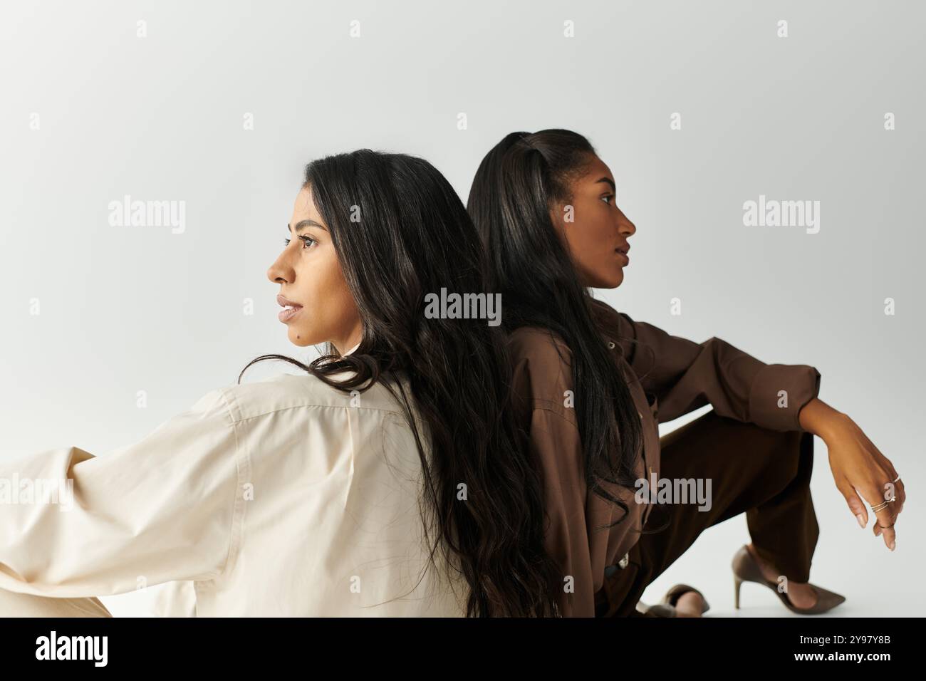 Two young women showcase their fashionable styles while posing ...