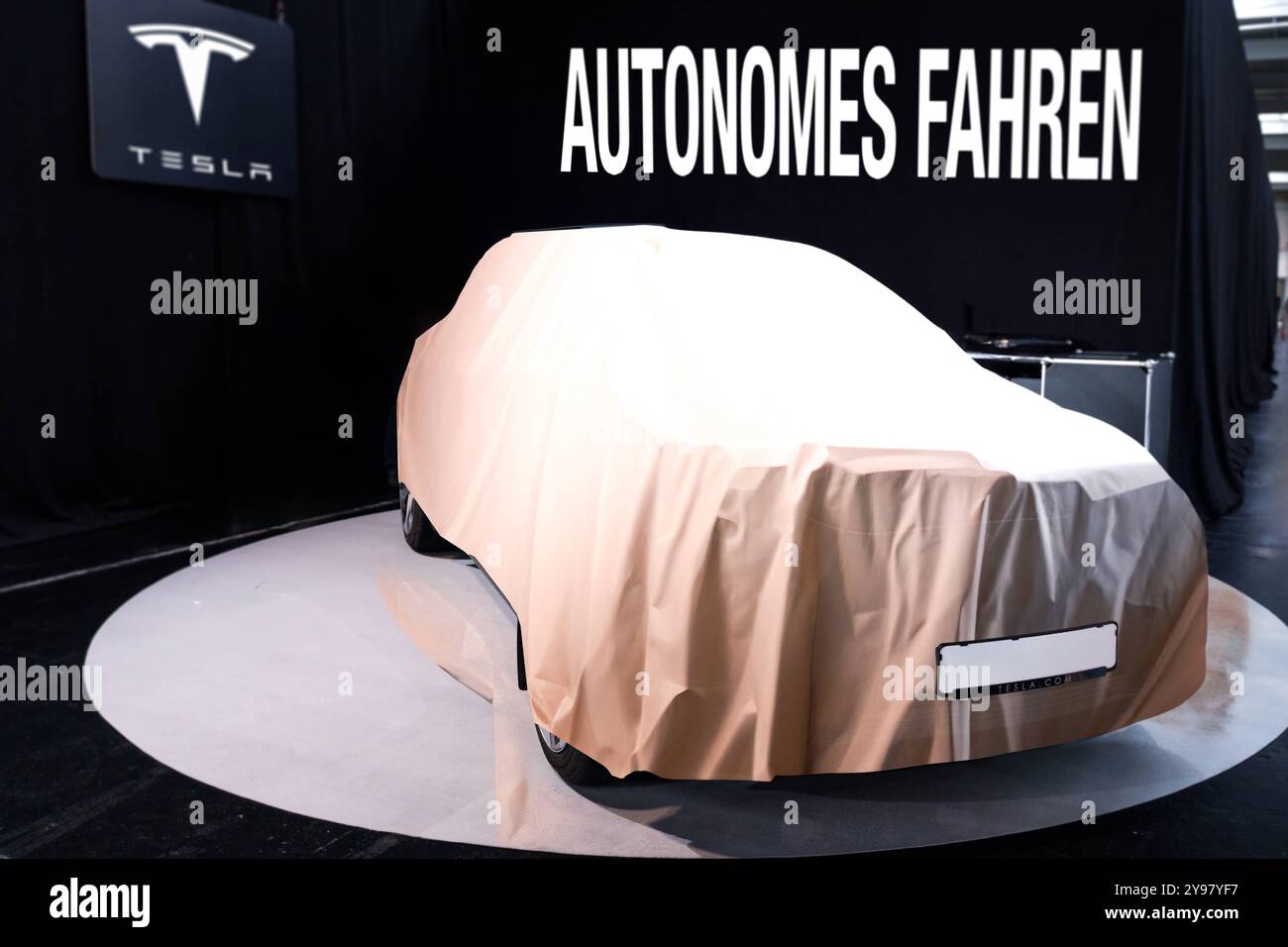 9 October 2024: An undercover Tesla vehicle stands under the banner ...