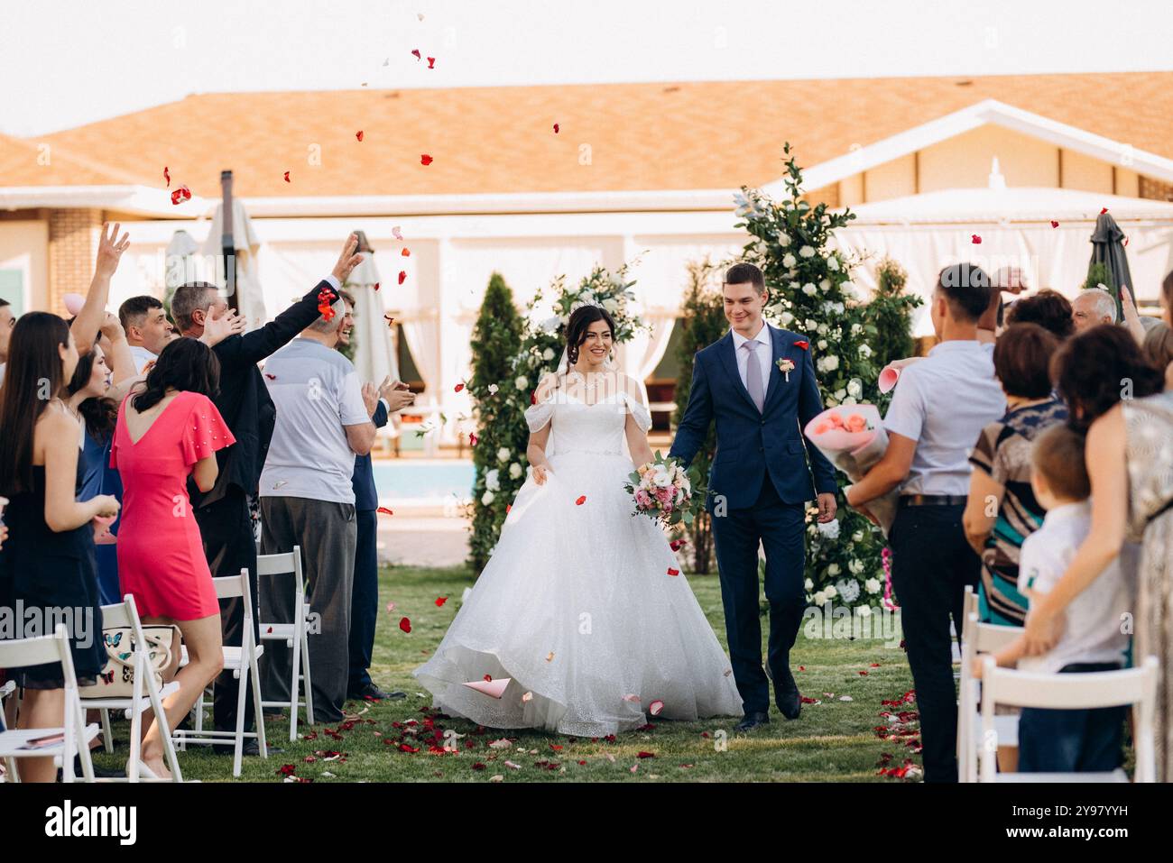wedding ceremony of the newlyweds on the glade near the restaurant ...