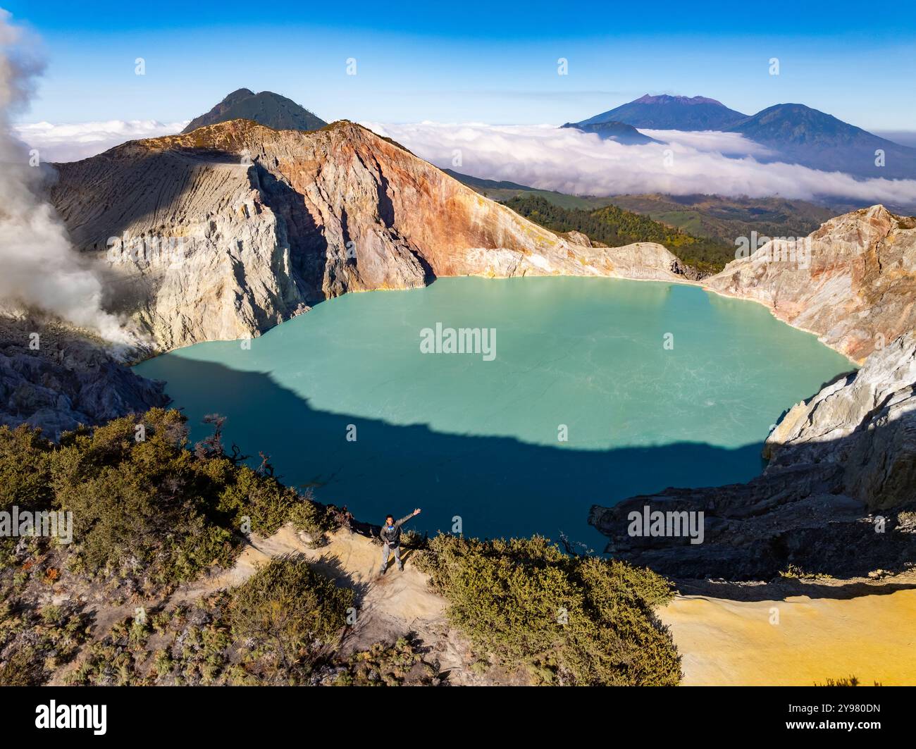 Aerial view Kawah Ijen volcano with turquoise sulfur water lake at sunrise.Amazing nature ...