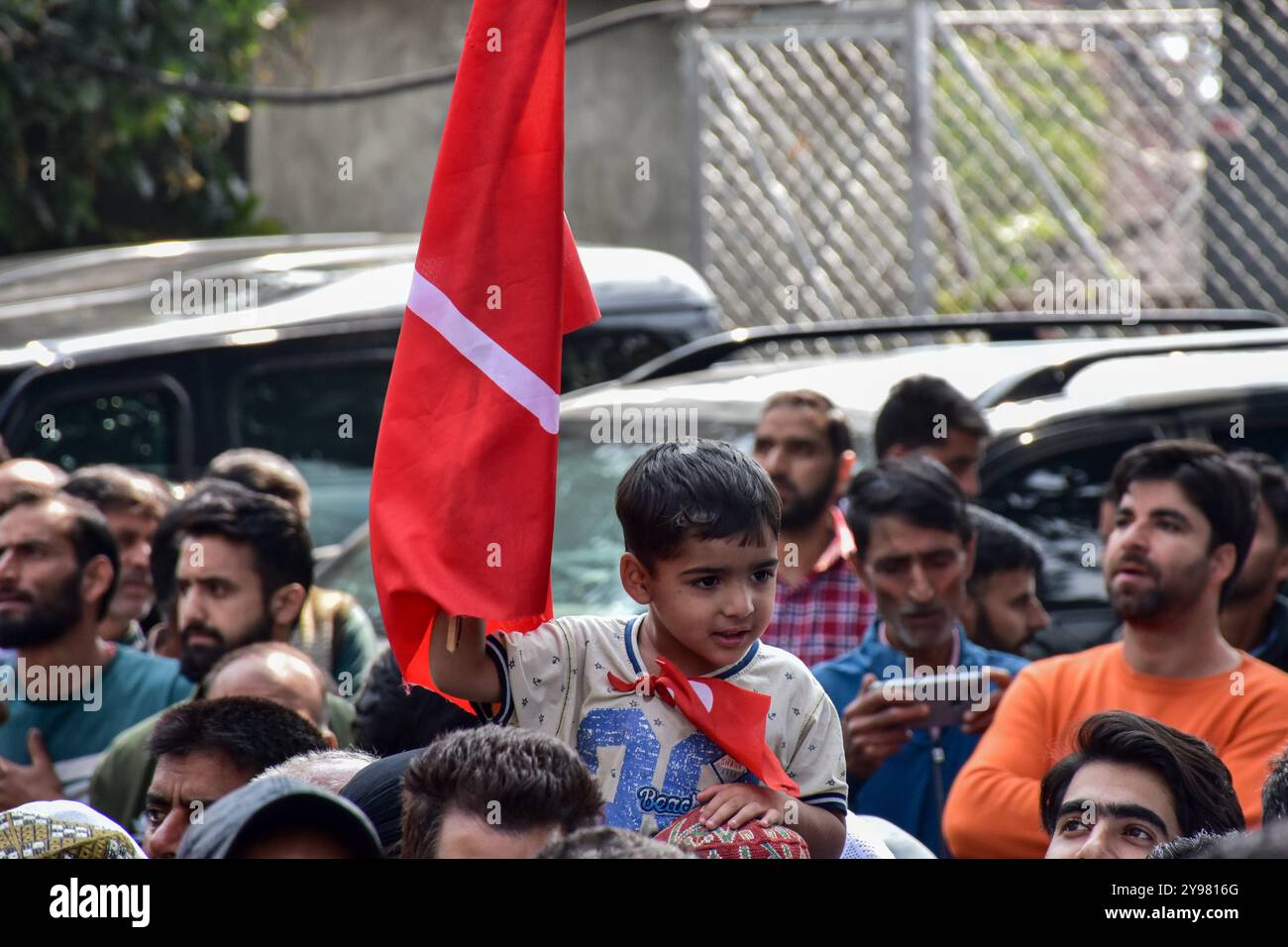 A supporter of Jammu and Kashmir National Conference (JKNC) party holds ...