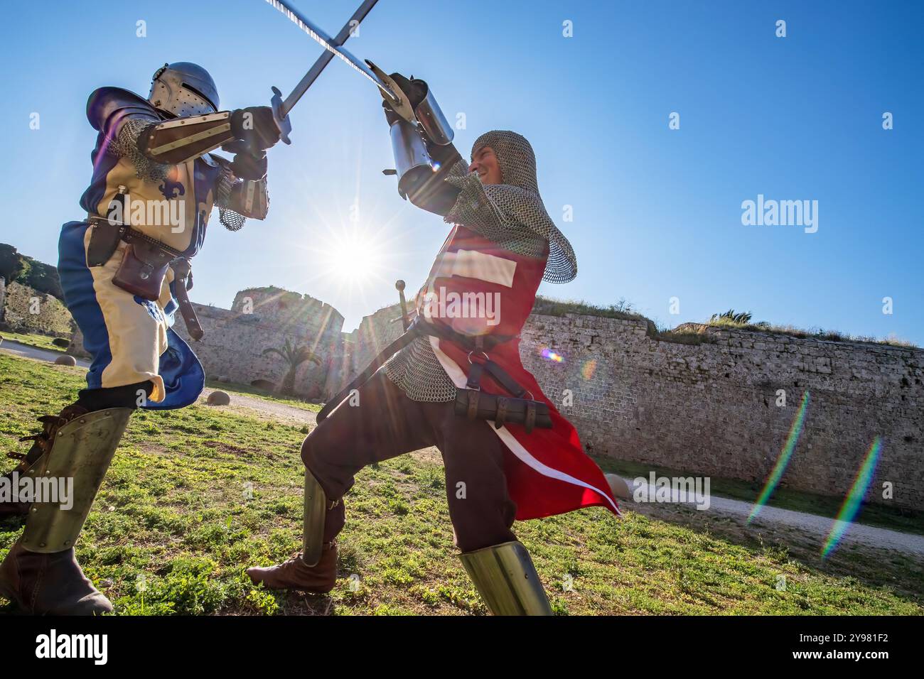 Two medieval knights battle each other in a swordfight as part of the ...