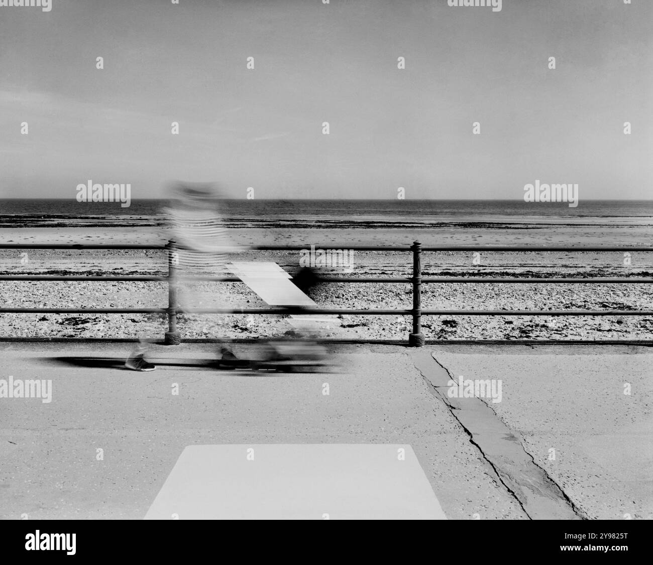 Moving person with pushchair on a seaside prom take on 5x4 film camera ...