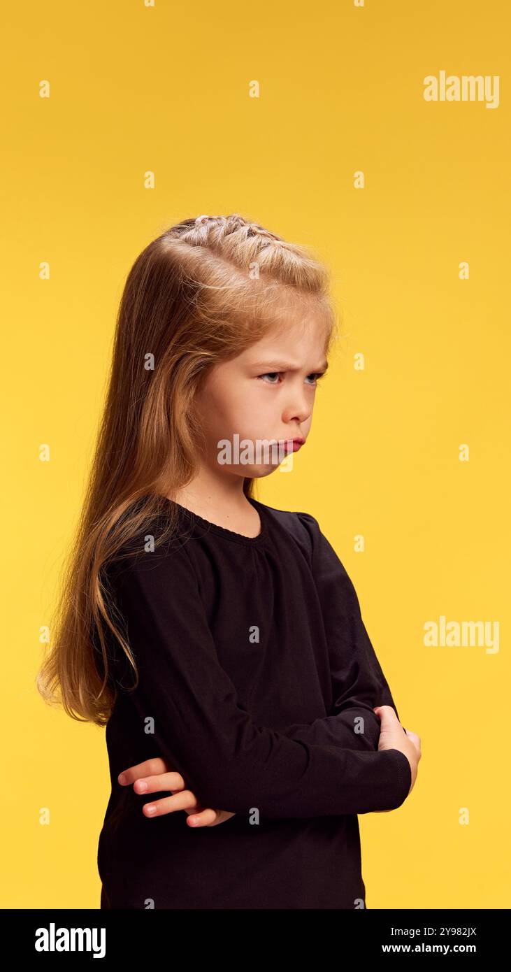 Side view photo of little girl with long blonde hair crosses her arms ...