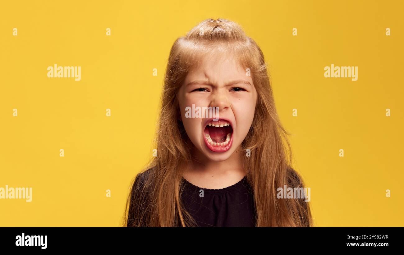 Little girl lets out loud, powerful yell, showing her temper against ...