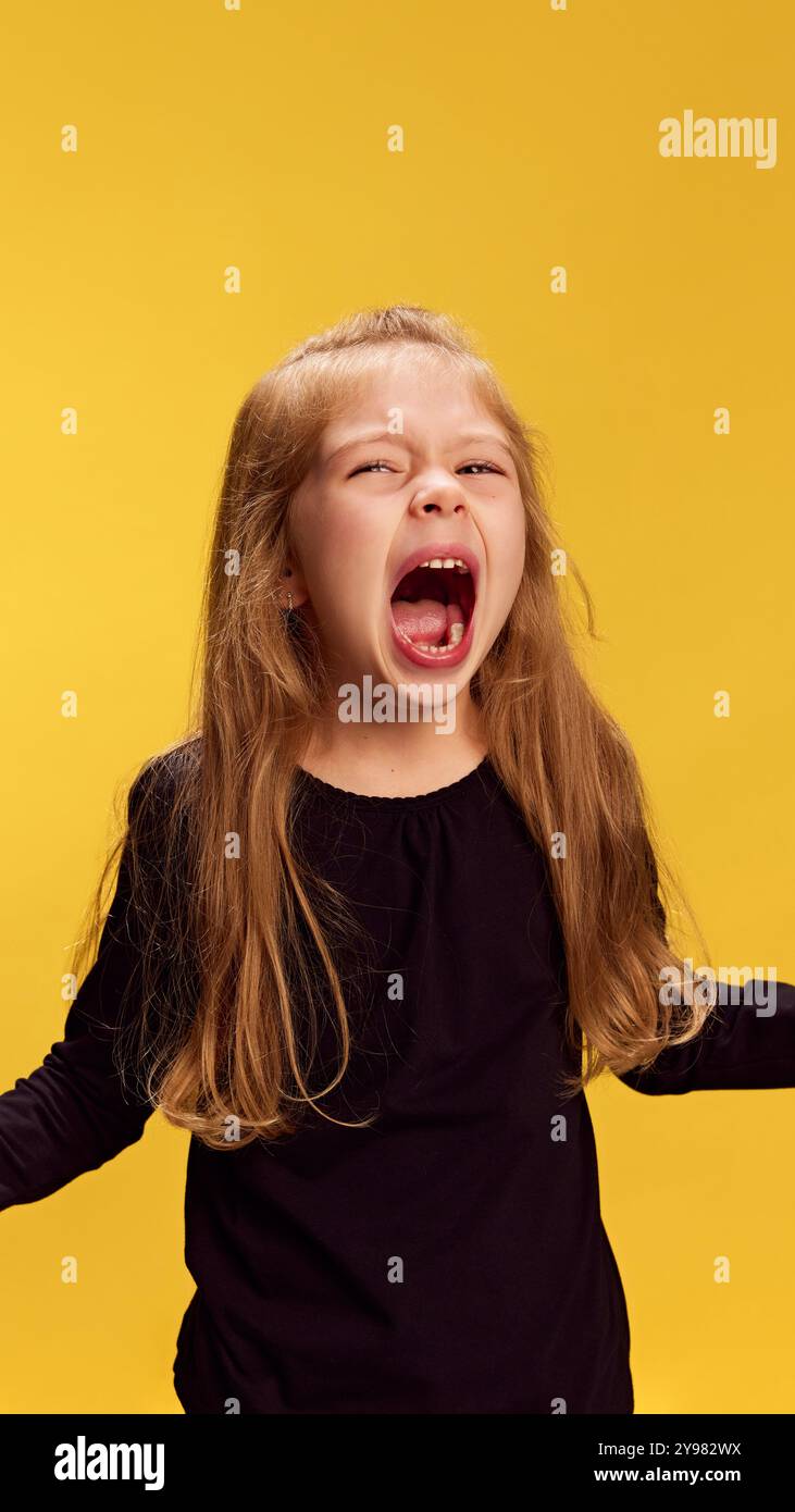 Little girl lets out loud, powerful yell, showing her temper against ...