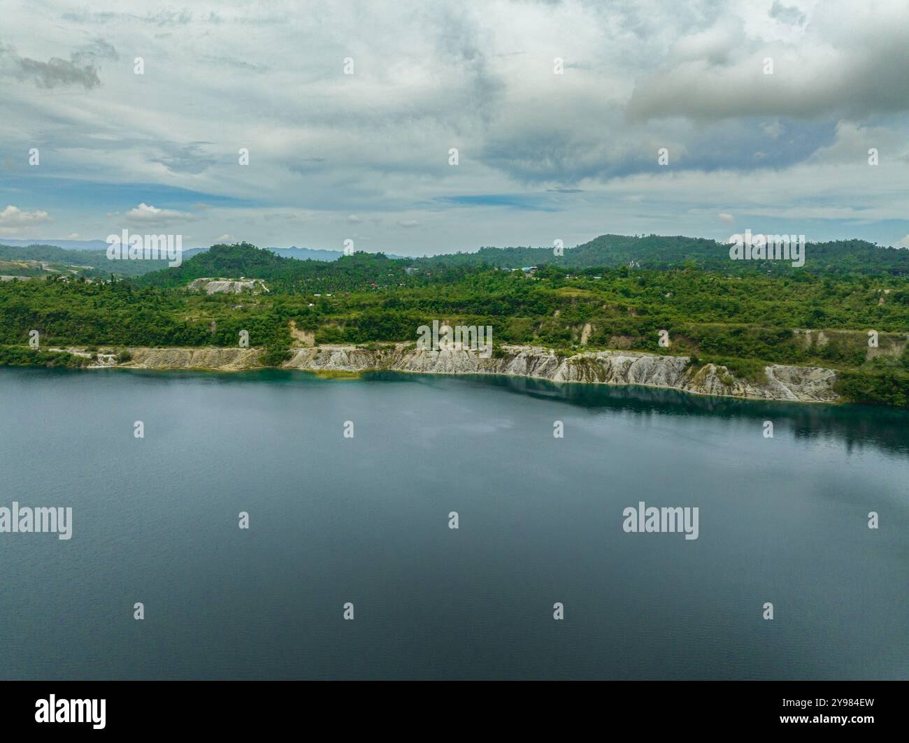 Aerial drone of mining quarry with flooded bottom. Lake with blue water ...