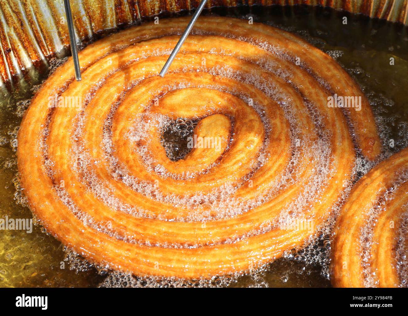 Traditional Adana Dessert Sari Burma aka Turkish Churro frying in a ...