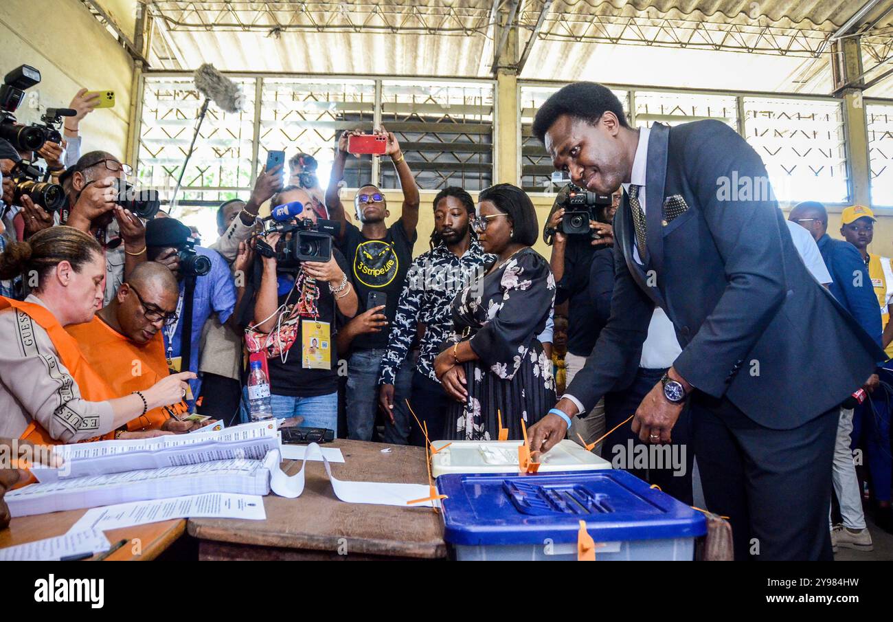 Independent candidate Venancio Mondlane, right, casts his vote in general elections in Maputo ...