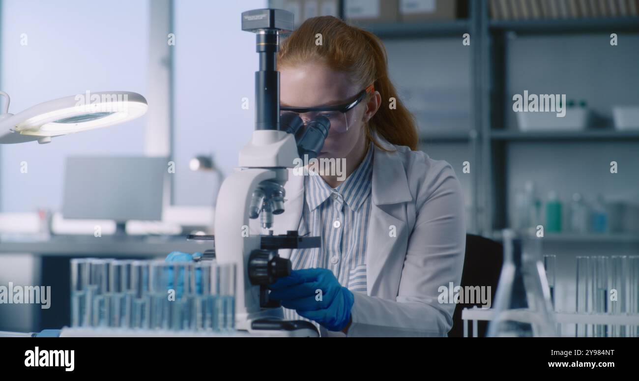 Bright medical science laboratory: Female biochemist takes liquid from ...